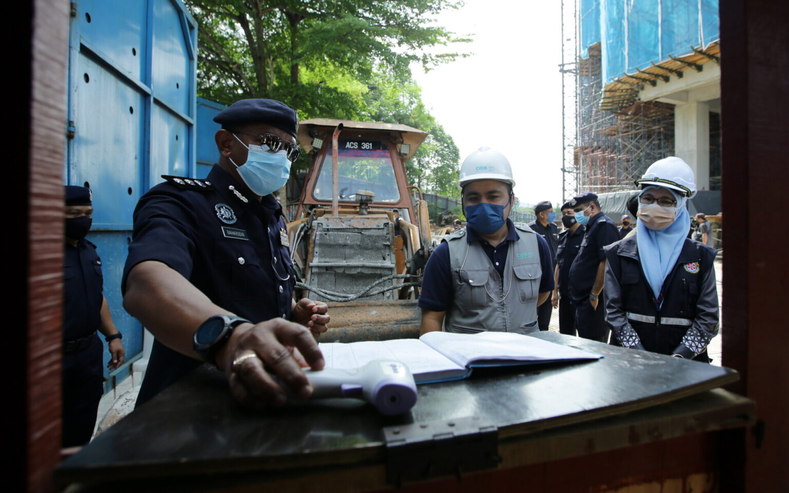 Factory Workers Climbing Over Fence To Escape From Raid? Police ...